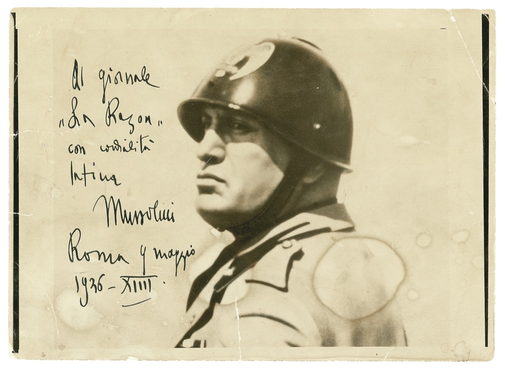 Benito Mussolini: Mussolini signs a martial portrait as the Fascist